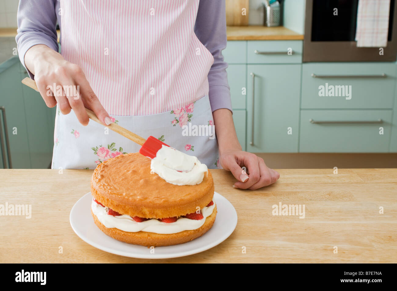 Woman making a cake Stock Photo - Alamy