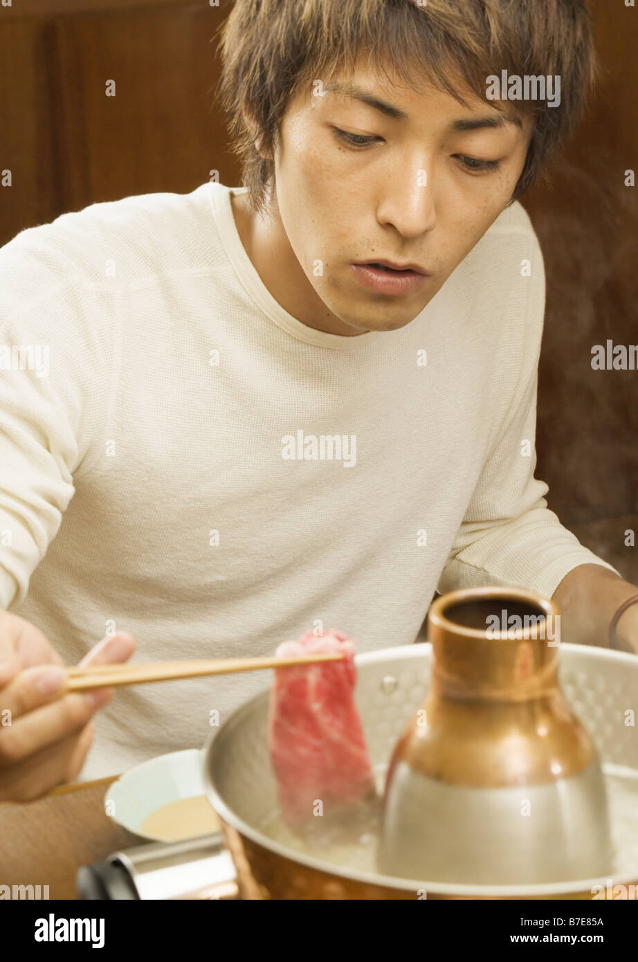 Man Eating Beef One-Pot Stock Photo - Alamy