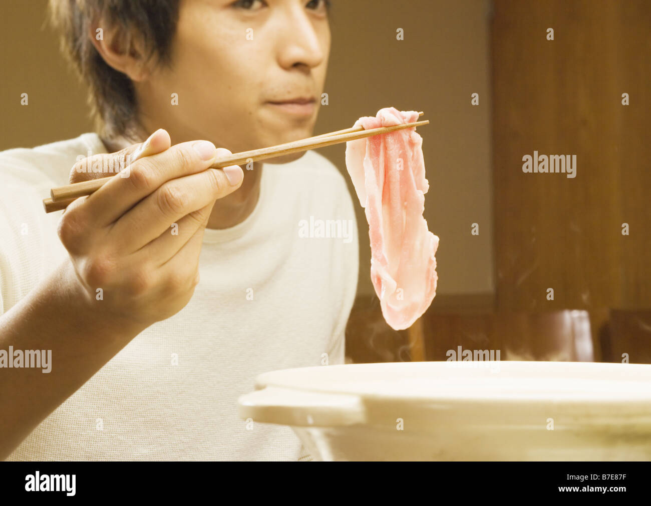 Man Eating Pork One-Pot Stock Photo - Alamy