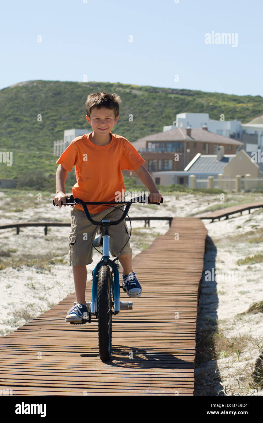 Boy riding bicycle Stock Photo - Alamy