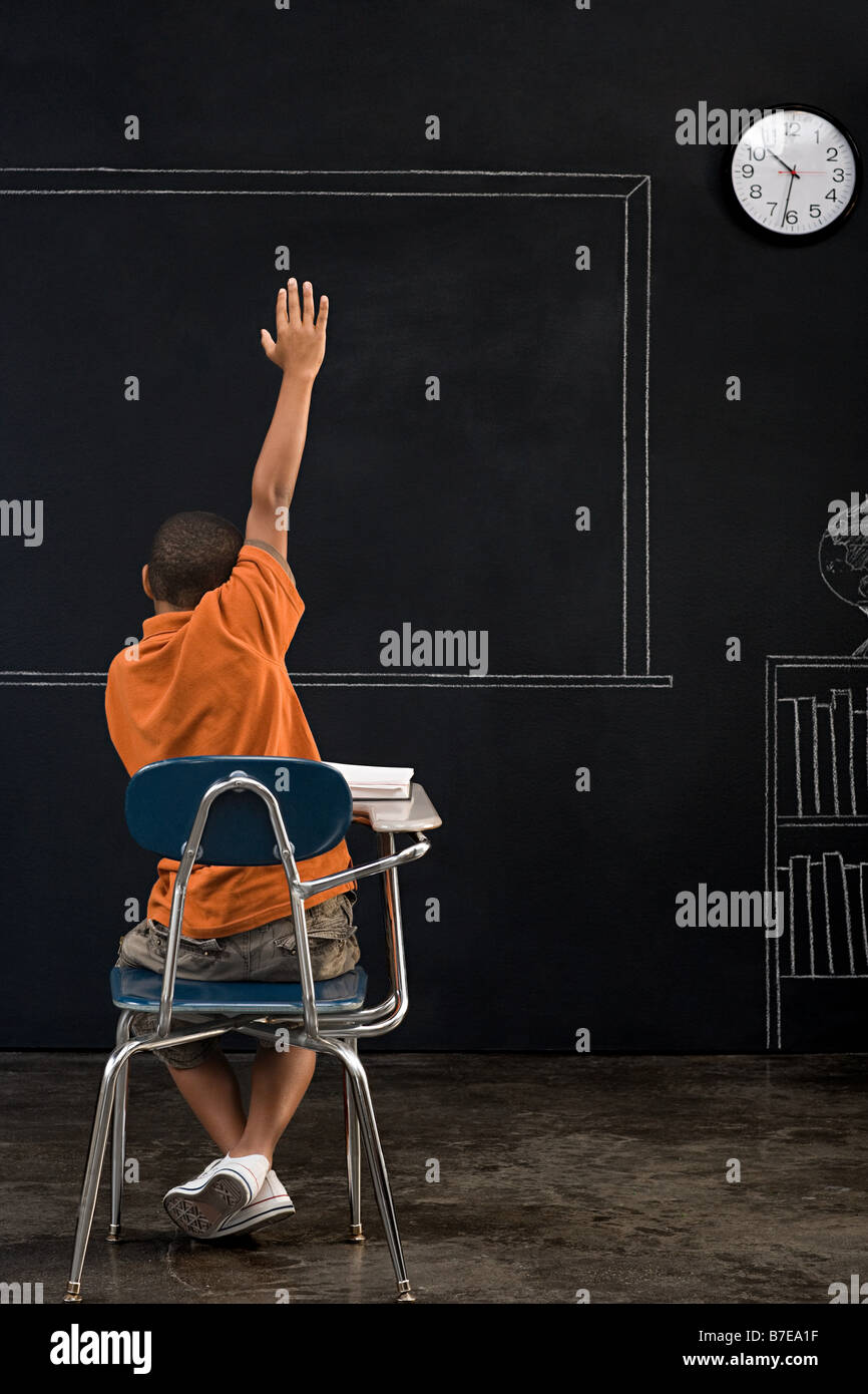 Rear view of a boy with his arm raised Stock Photo - Alamy