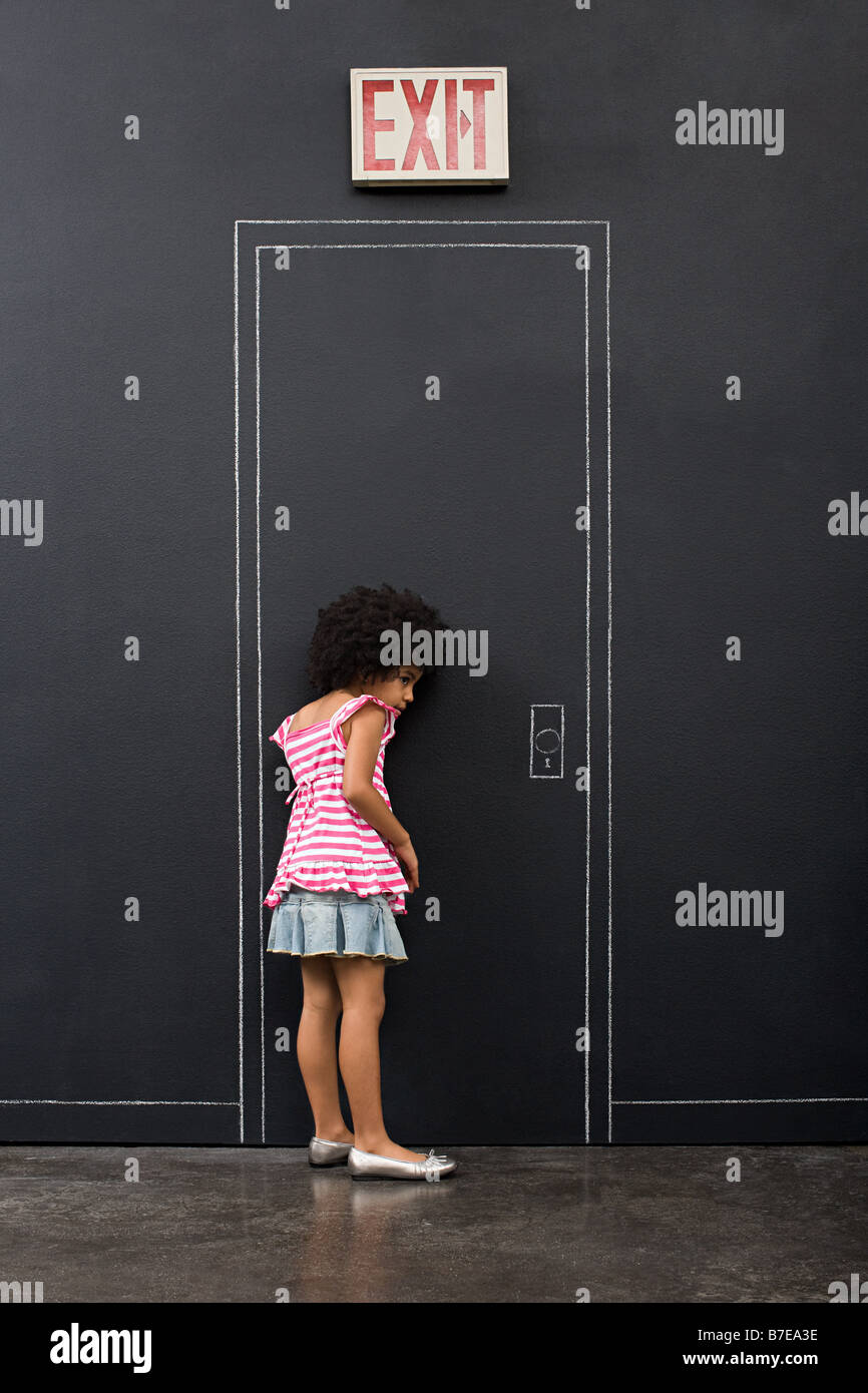 A girl listening by a door Stock Photo - Alamy