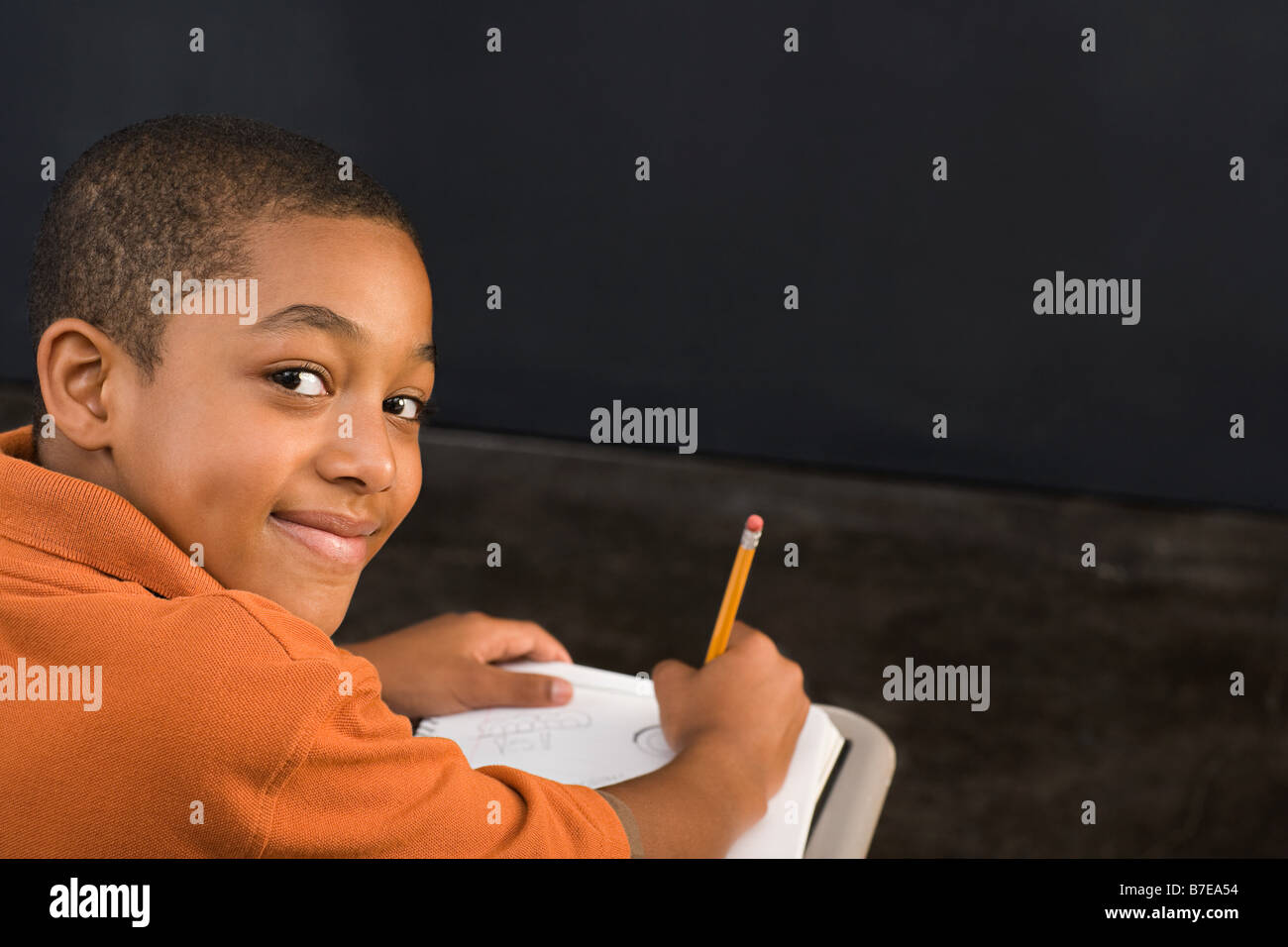 Portrait of a boy writing Stock Photo - Alamy
