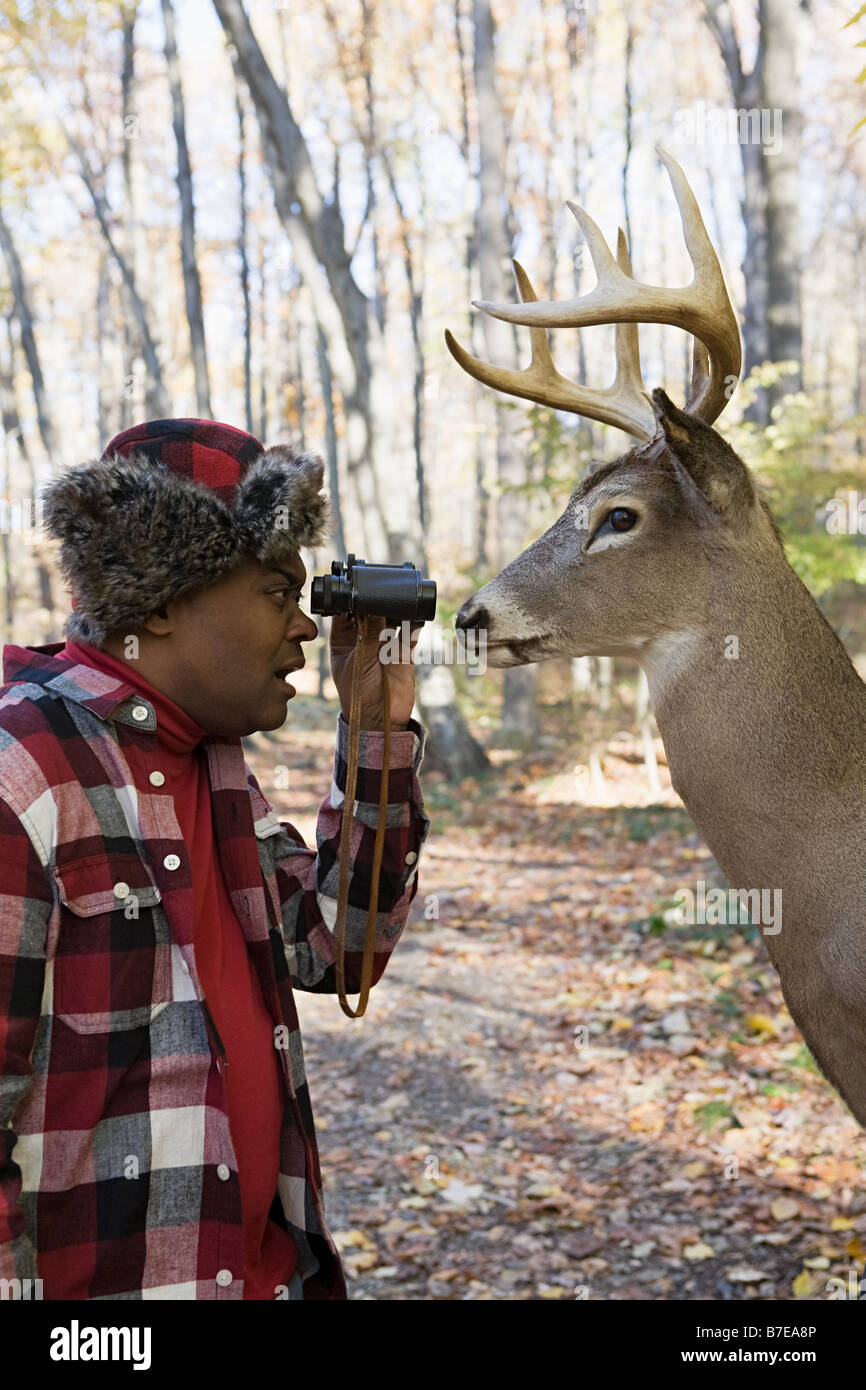 Hunter face to face with a deer Stock Photo - Alamy