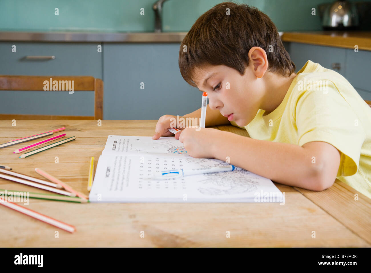 A boy colouring in Stock Photo - Alamy