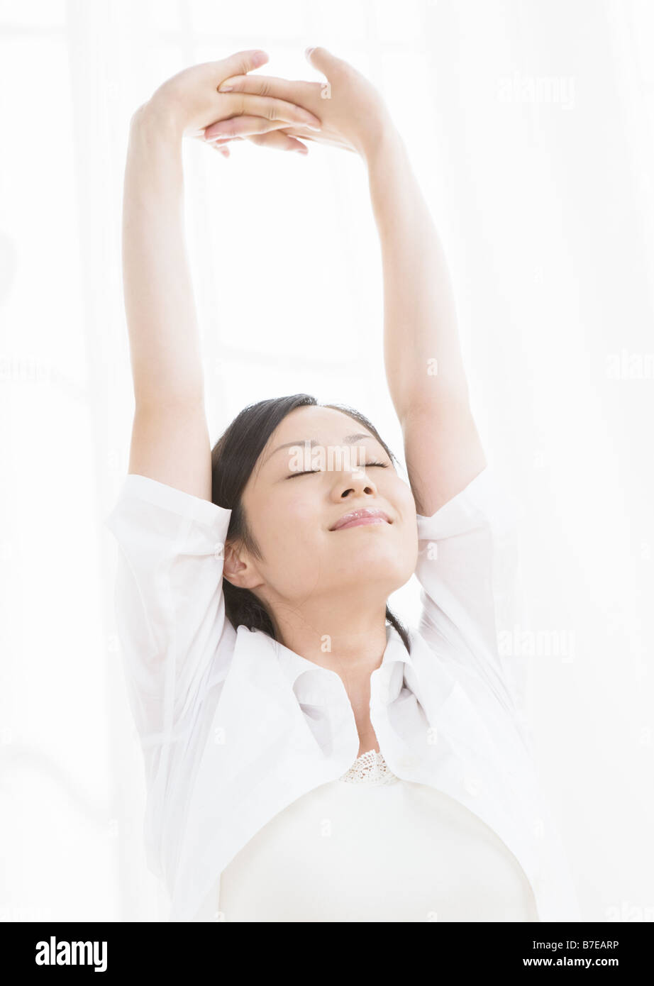 Woman stretching her arms Stock Photo - Alamy