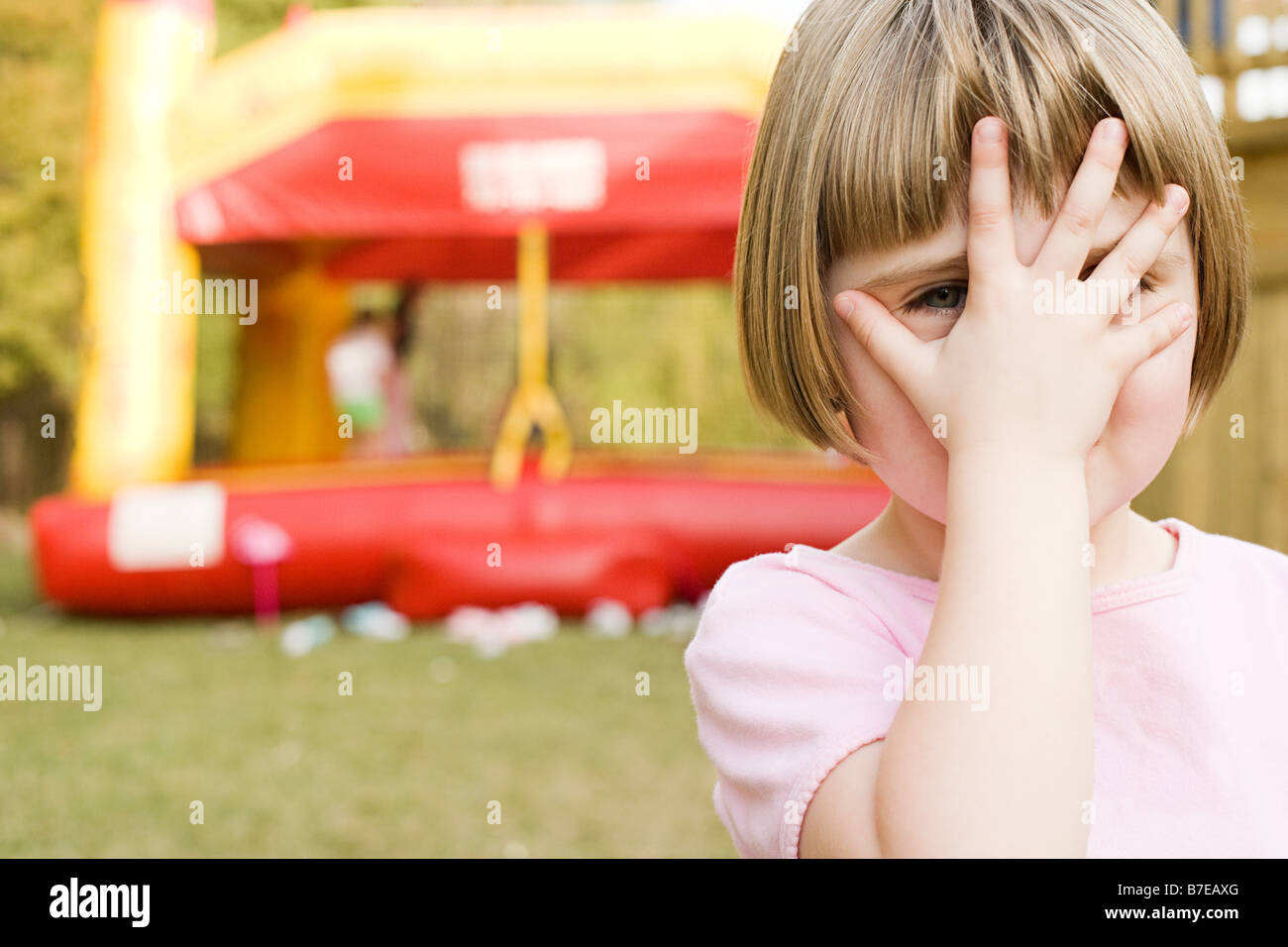 Girl with hand in front of face Stock Photo - Alamy