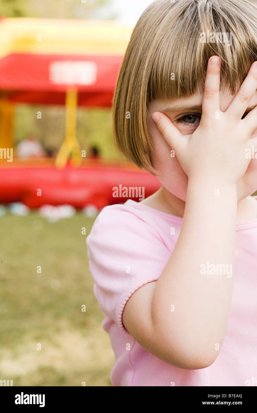 Girl with hand in front of face Stock Photo - Alamy