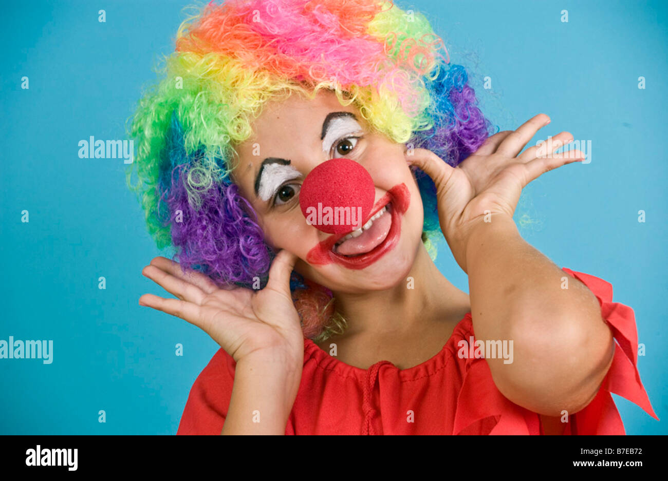 A child dressed in a clown costume playing the part Stock Photo - Alamy