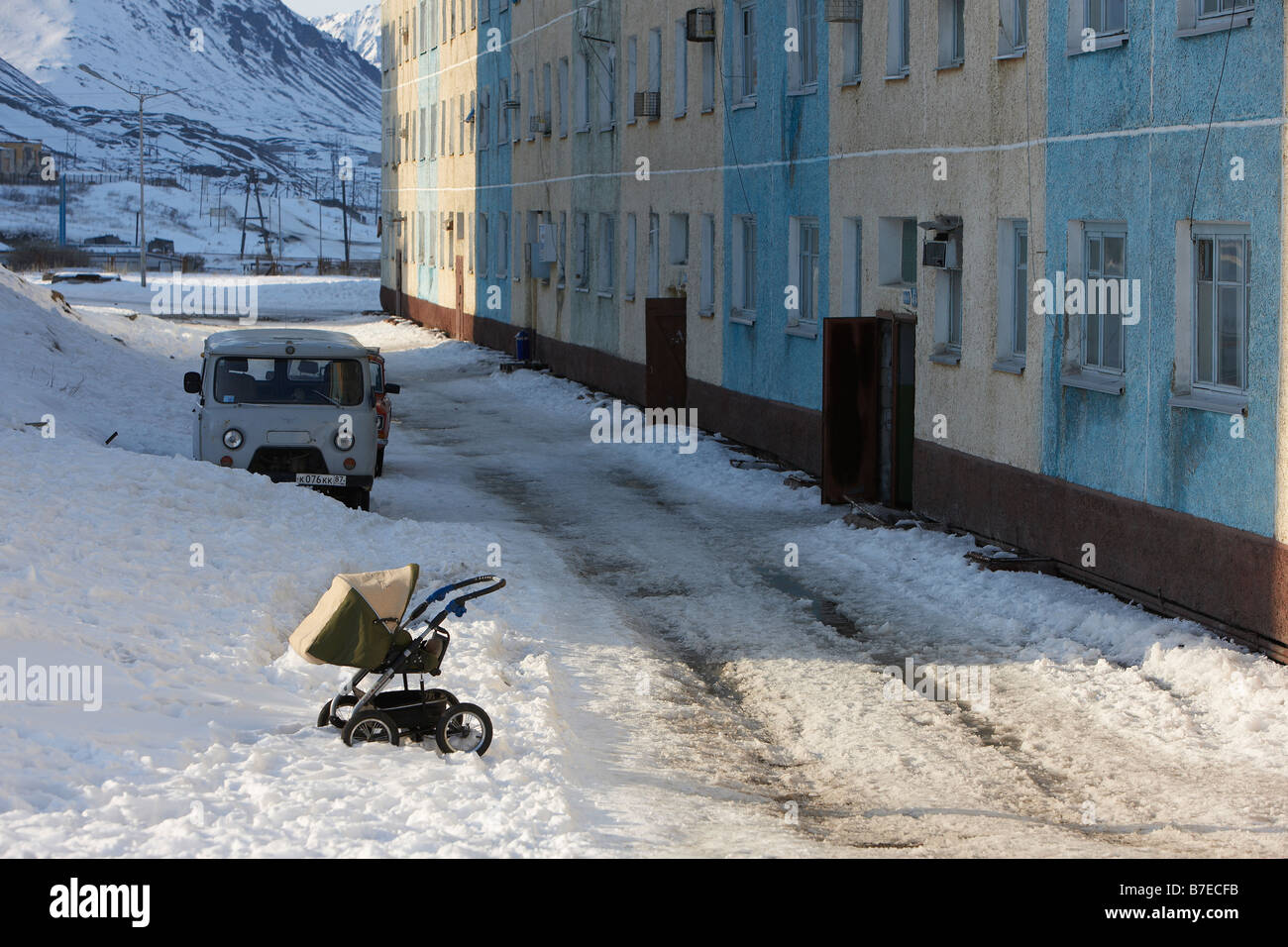 Baby Stroller in snow by apartment building, Egvekinot, Chukotka ...