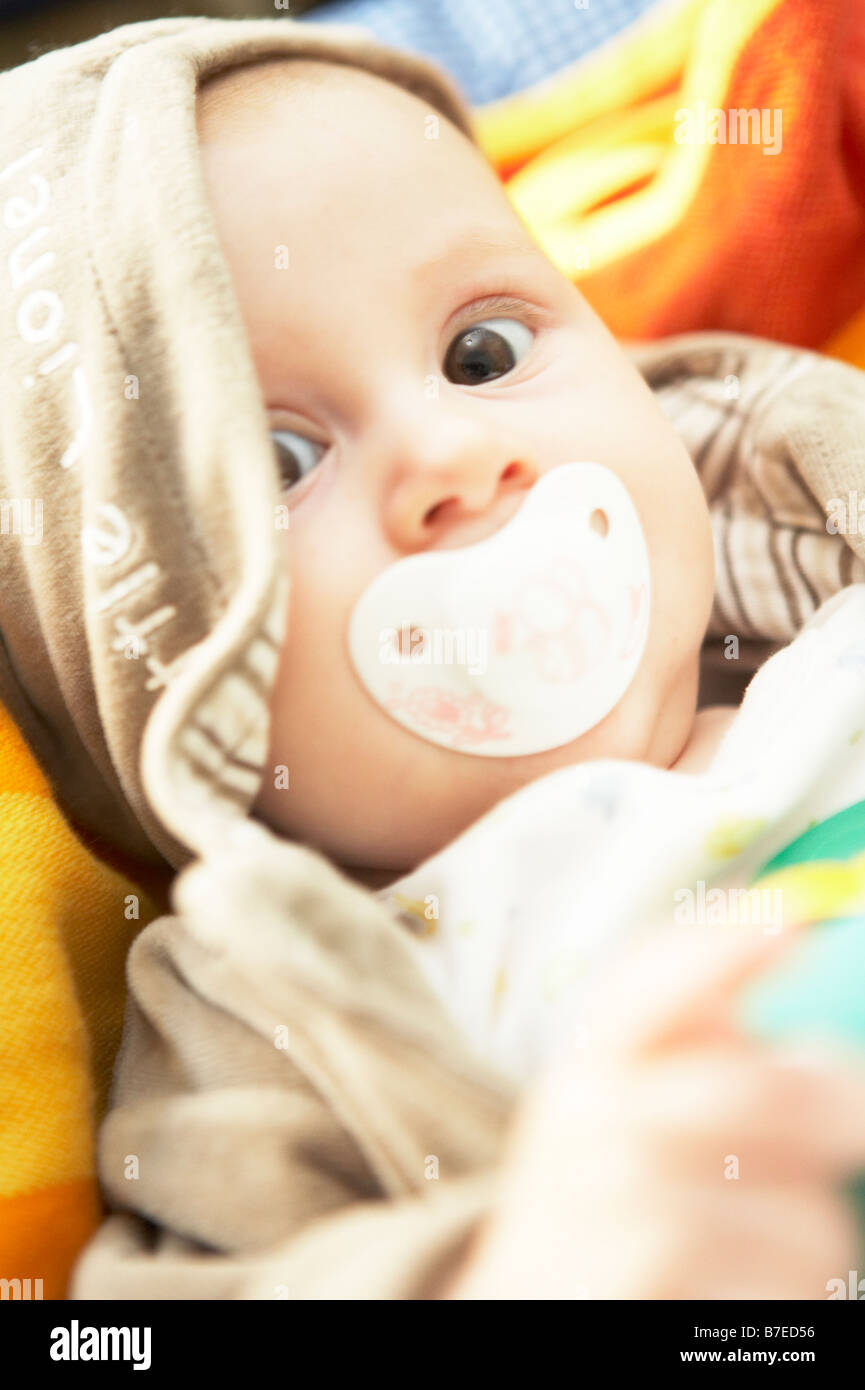 Baby with hood and comforter Stock Photo - Alamy