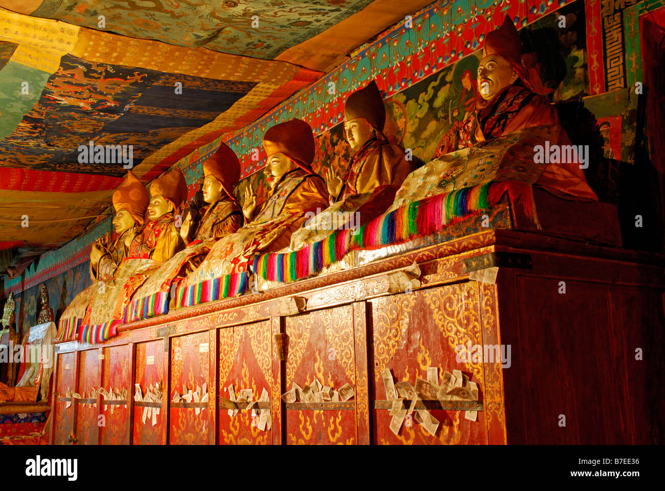 Old Buddhist statues of the Gelugpa Yellow Hat order line the wall at ...