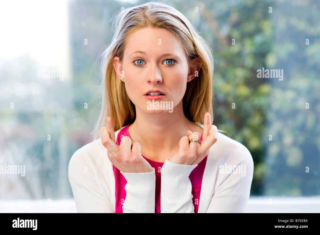 Woman with fingers crossed Stock Photo - Alamy