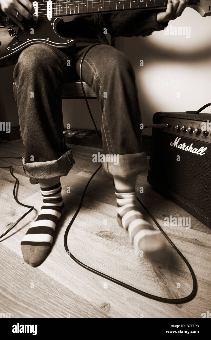Foot tapping to music from an electric guitar and amplifier Stock Photo ...