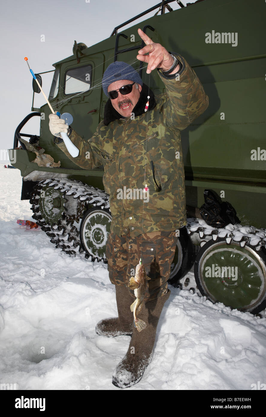 Ice fishing for smelts in front of modified tank (Vezdekhod), Anadyr ...