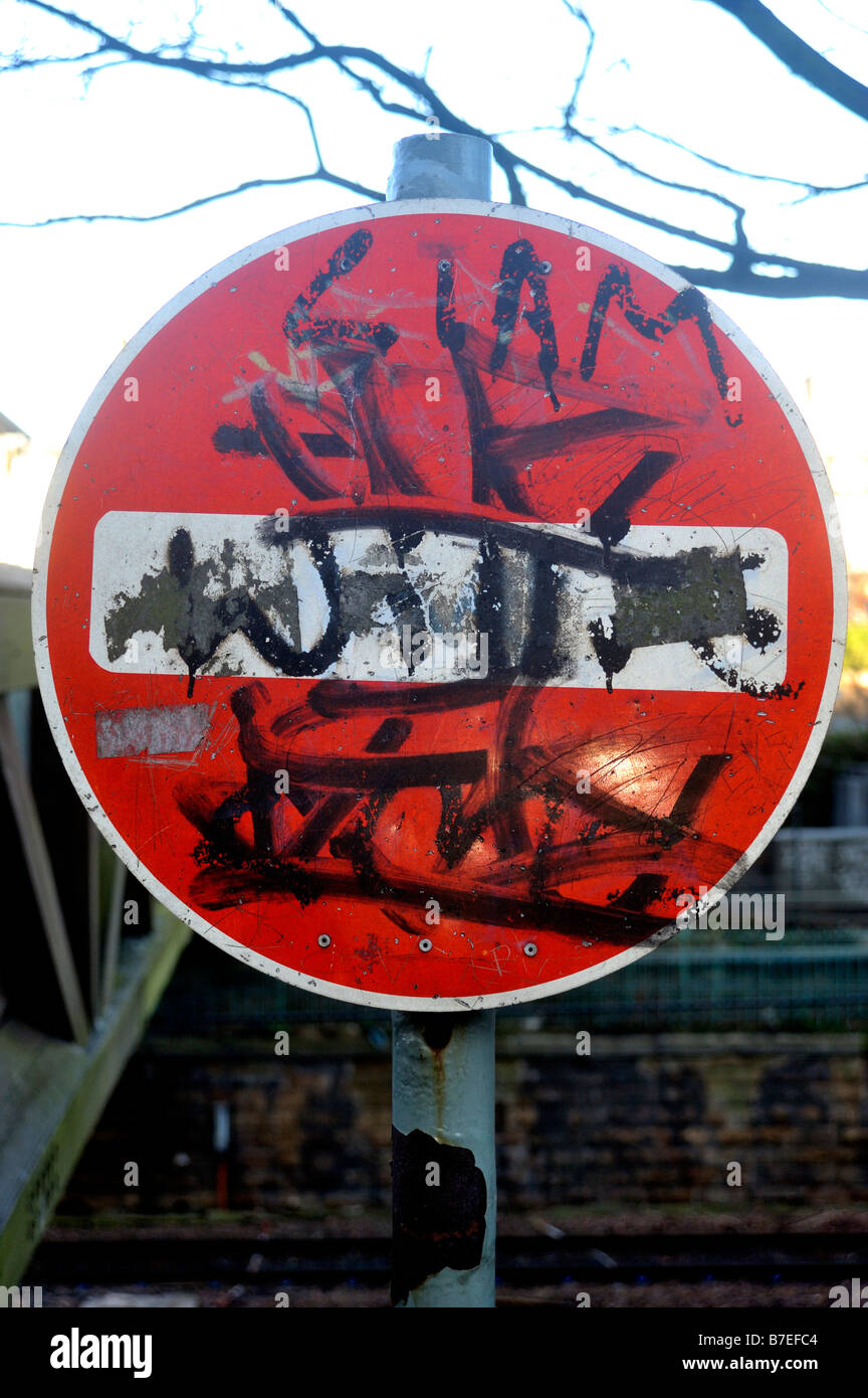 A "no entry" sign which has been covered with graffiti Stock Photo - Alamy