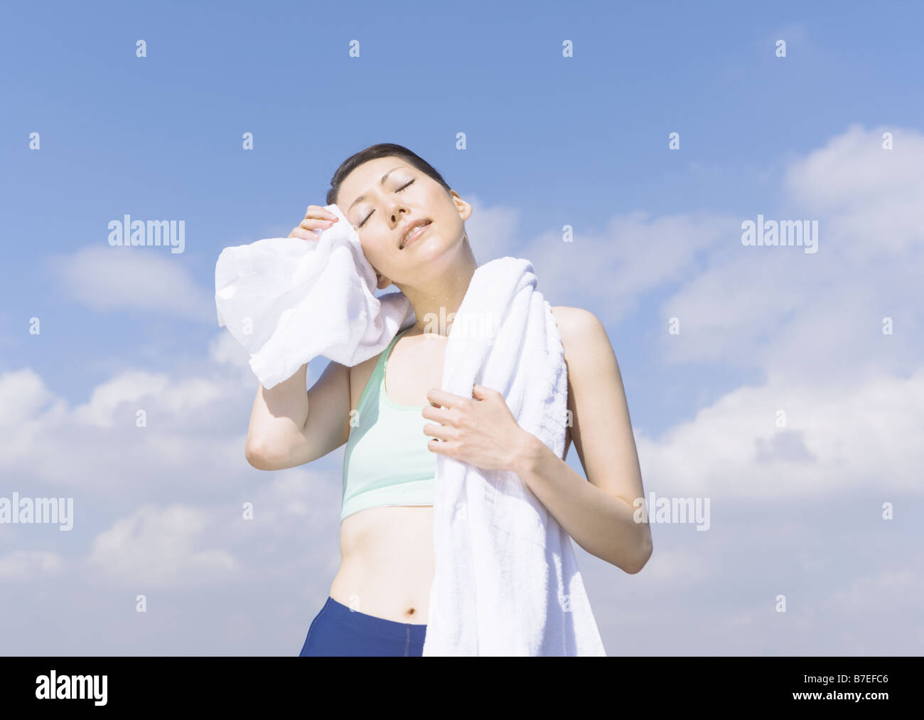 Woman wiping back with towel hi-res stock photography and images - Alamy