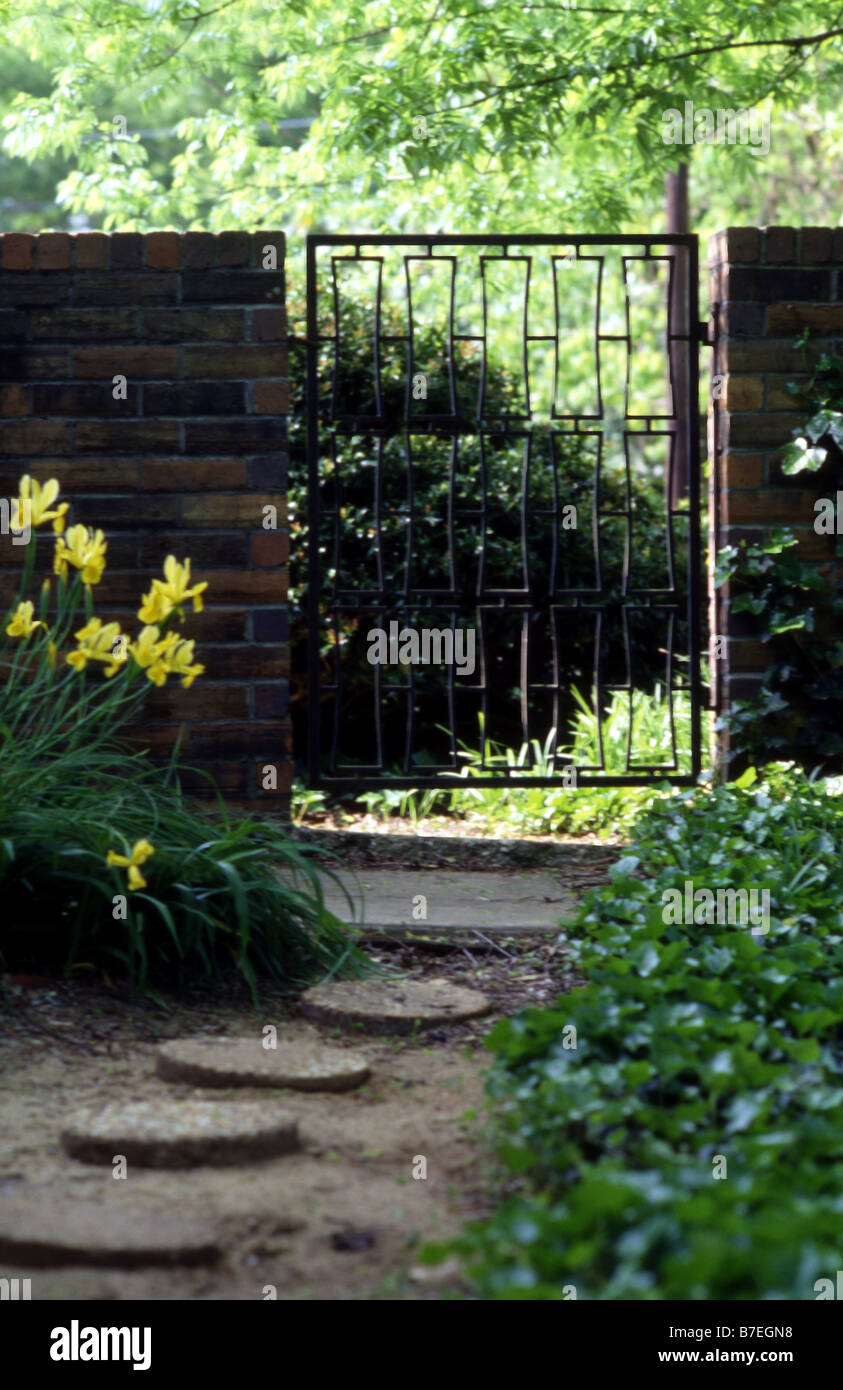 a garden gate and path with walking stones and flowers Stock Photo - Alamy