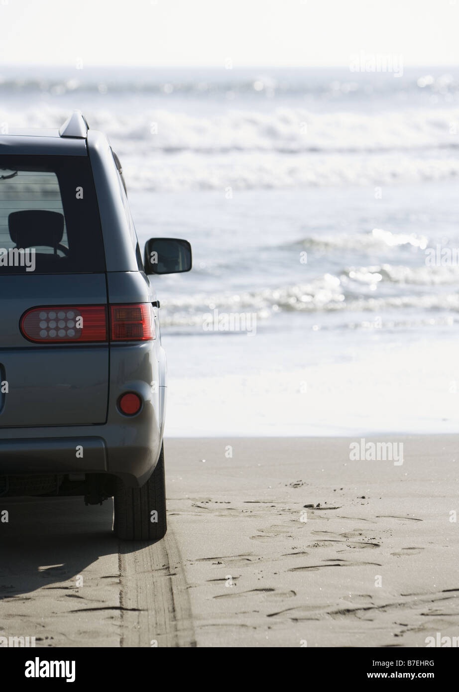 Car on a sandy beach Stock Photo - Alamy