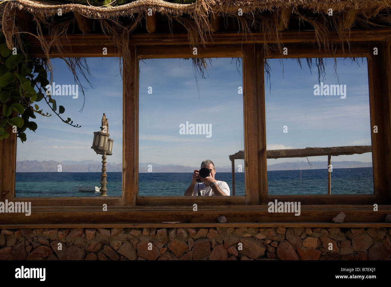 a self portrait in a reflective window in dahab egypt Stock Photo - Alamy