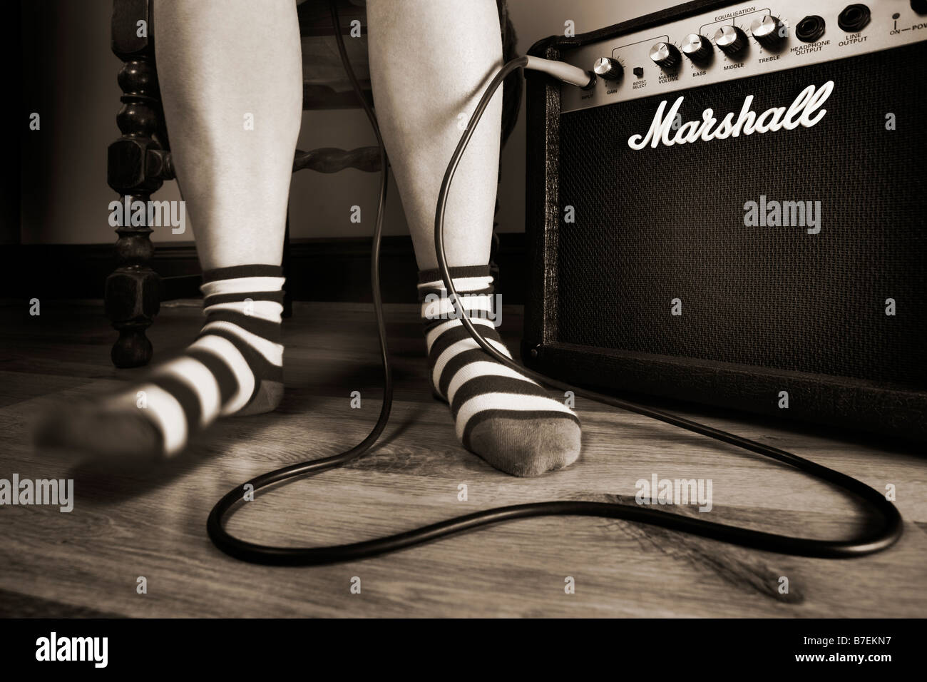 Foot tapping to music from an amplifier Stock Photo - Alamy