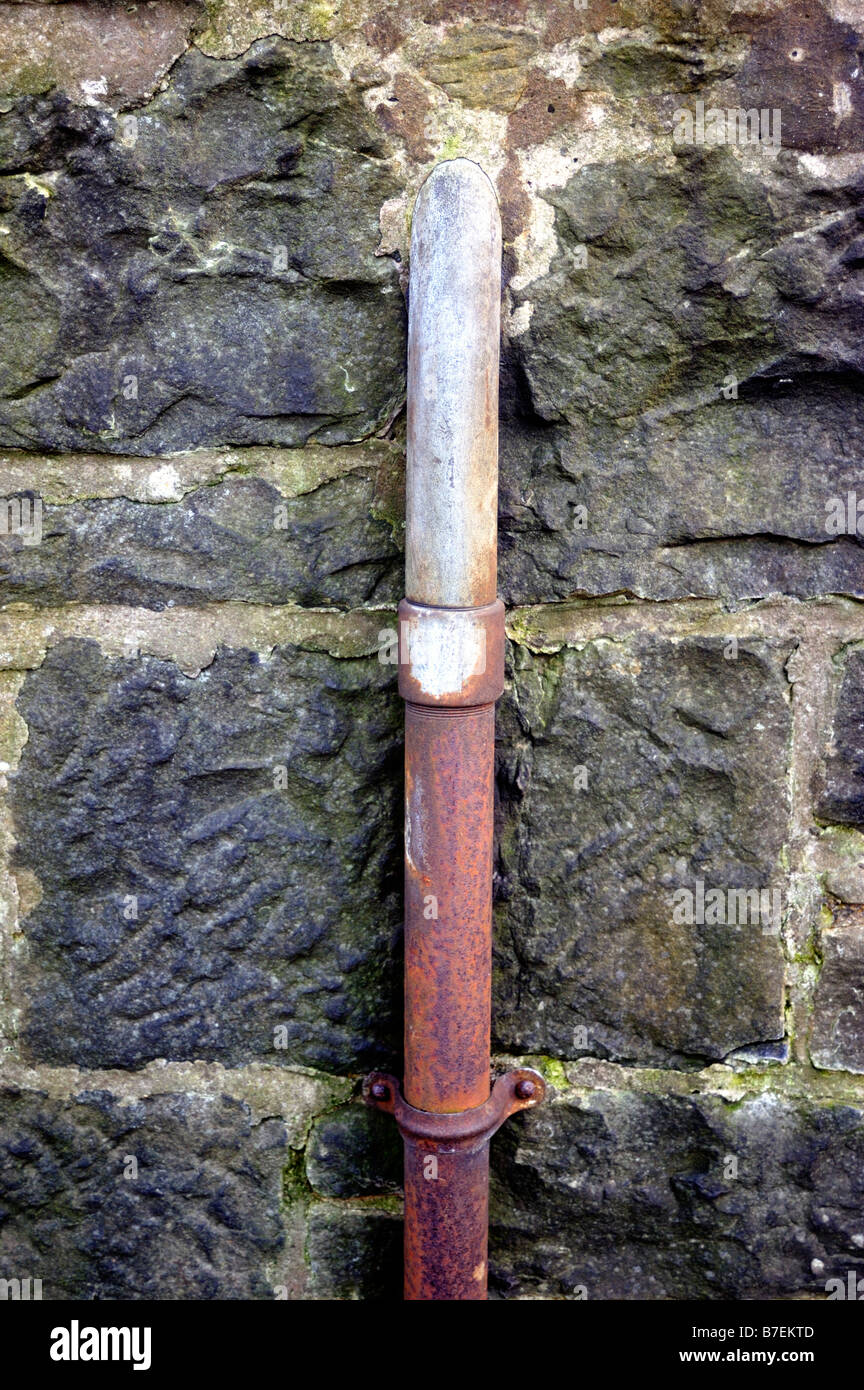 Pipe in an old stone wall Stock Photo - Alamy