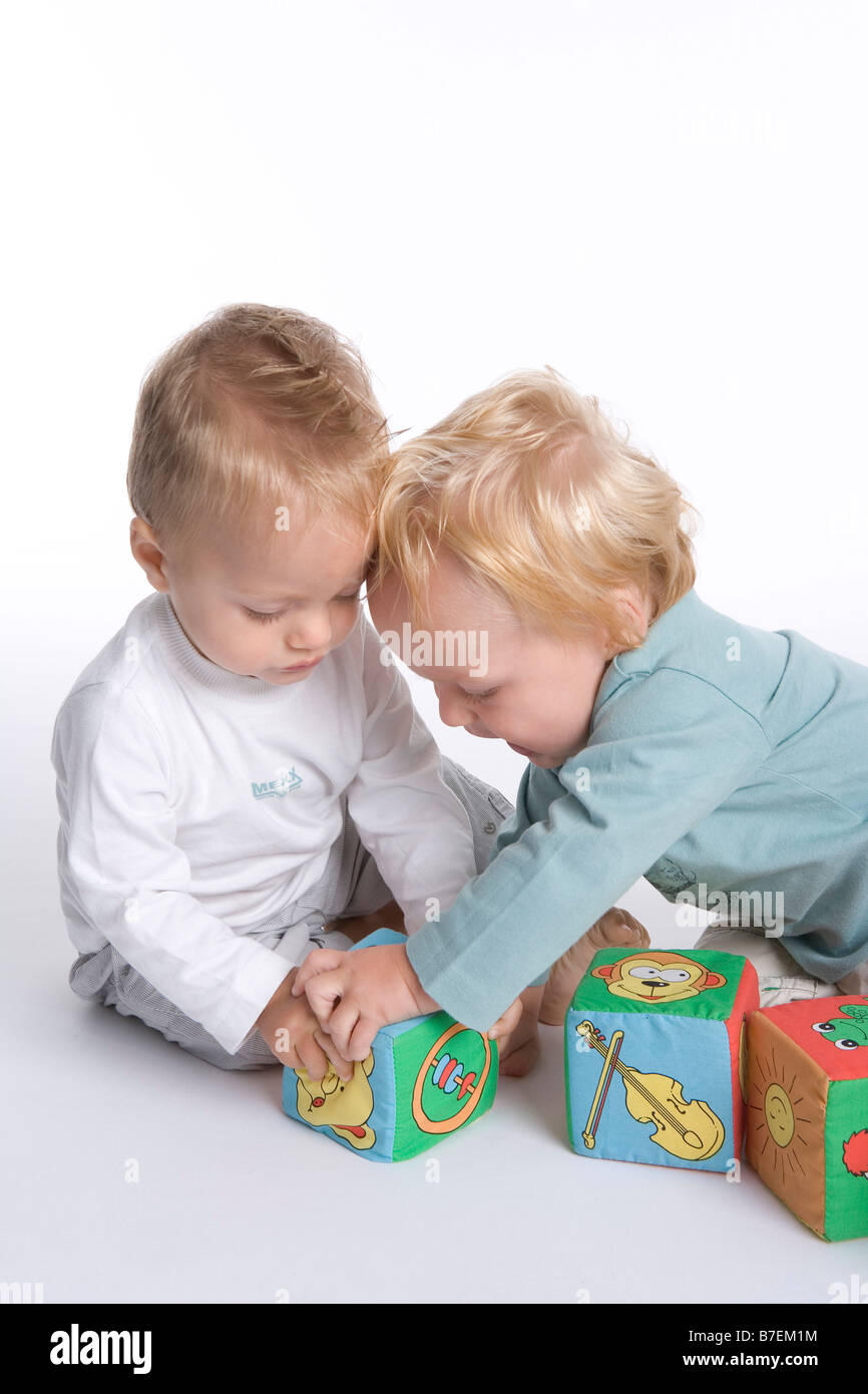 Two toddler quarrel about soft bricks Stock Photo - Alamy