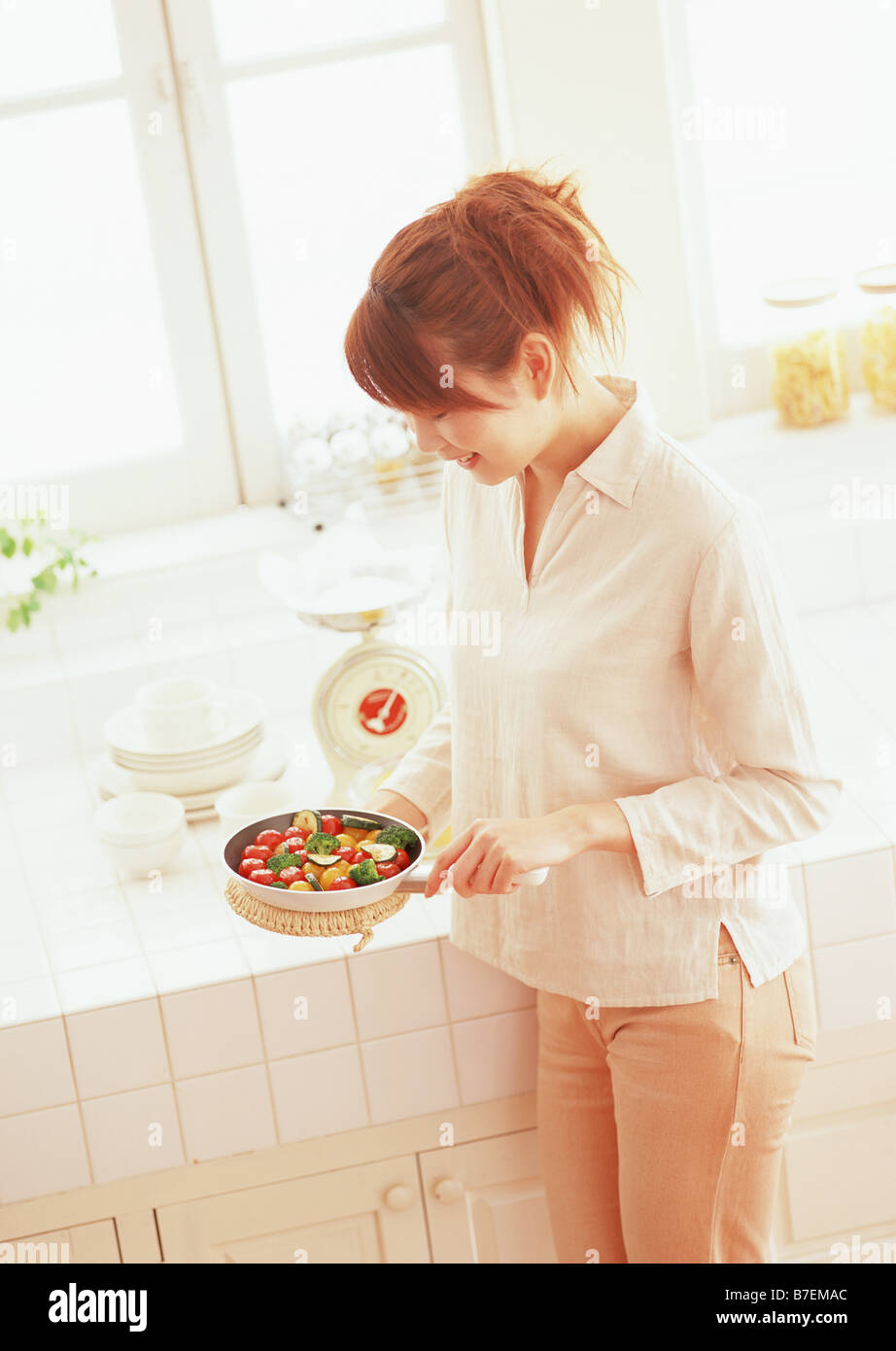 Woman in kitchen Stock Photo - Alamy