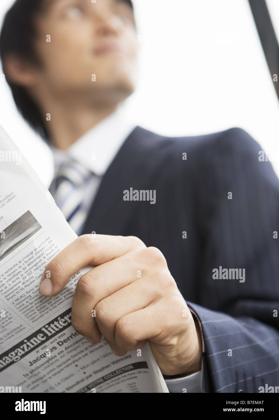 Close-up of businessman's hand holding a newspaper Stock Photo - Alamy