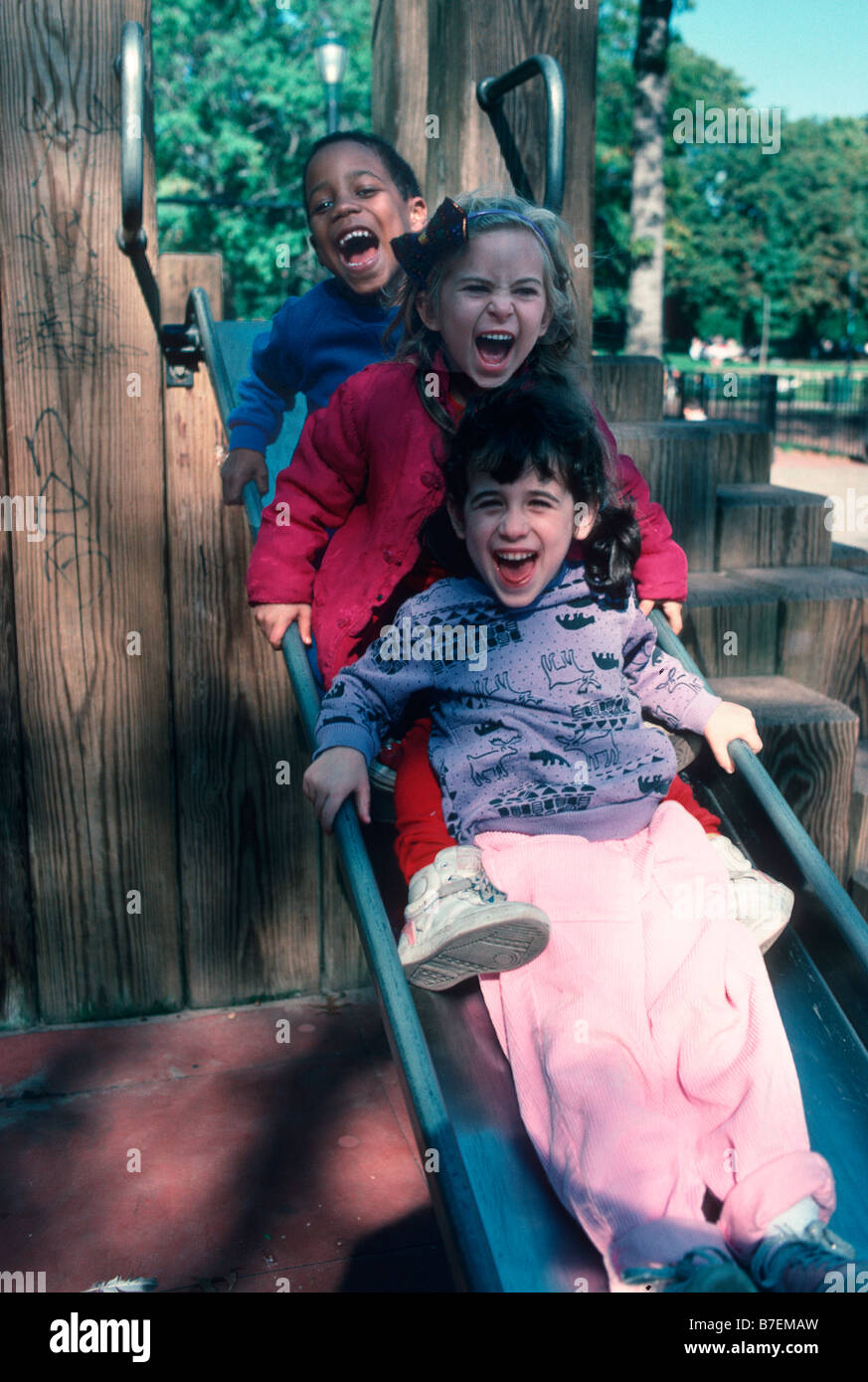 Children having fun on the slide at the playground in Brooklyn New York ...