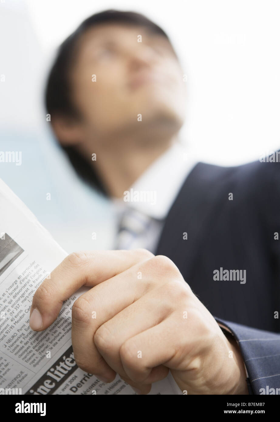 Close-up of businessman's hand holding a newspaper Stock Photo - Alamy