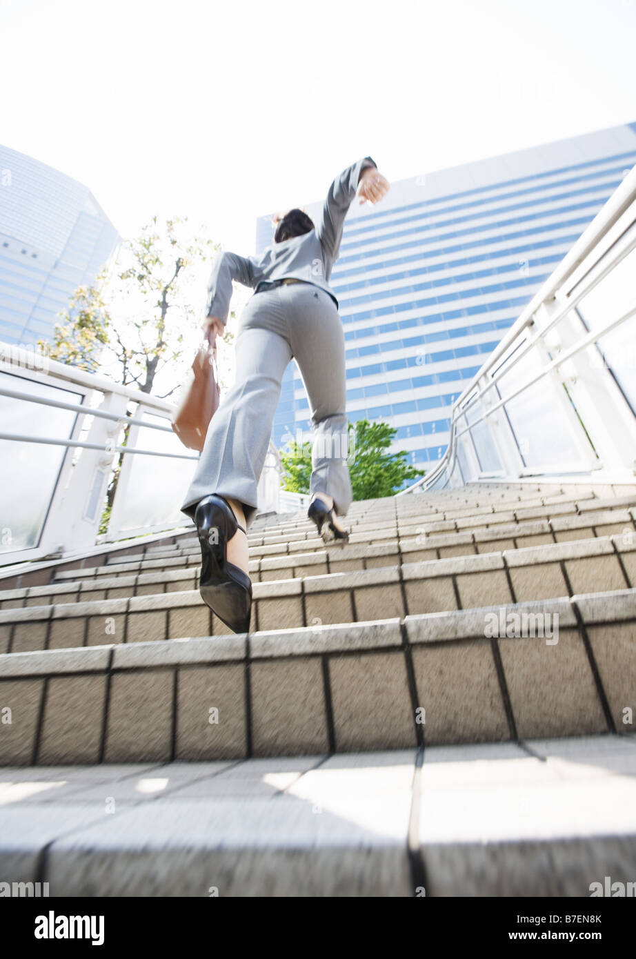Businesswoman running up stairs hi-res stock photography and images - Alamy