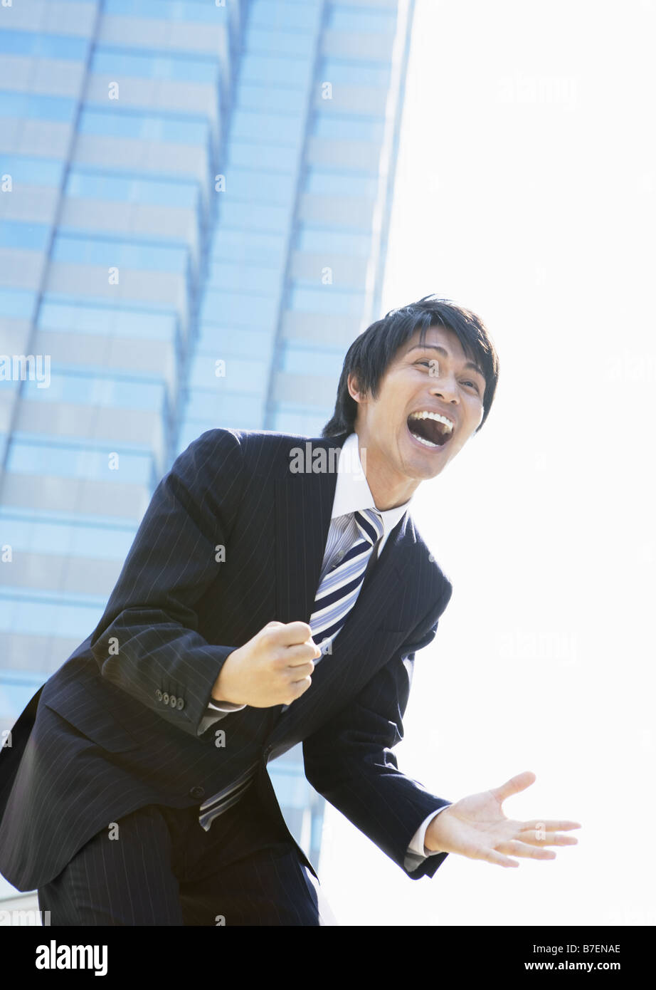 Businessman with victory pose Stock Photo - Alamy
