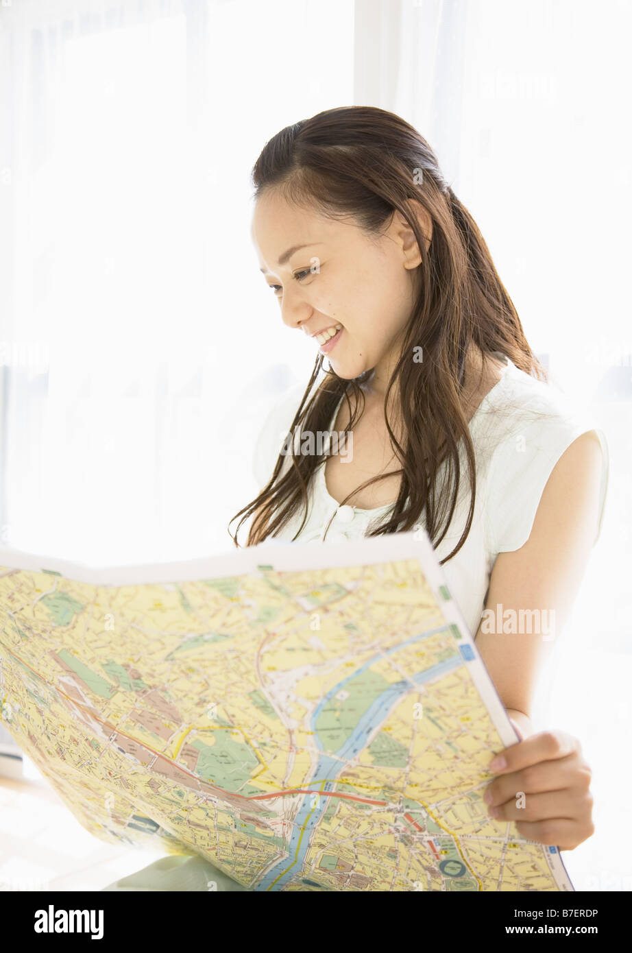 A woman looking at a map Stock Photo - Alamy