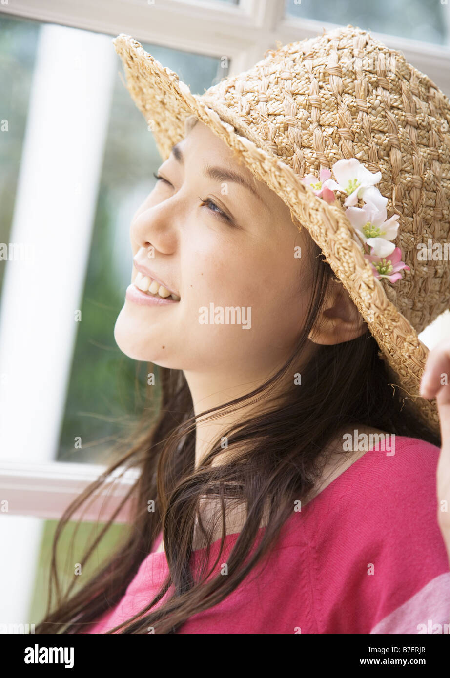 A woman wearing straw hat Stock Photo - Alamy