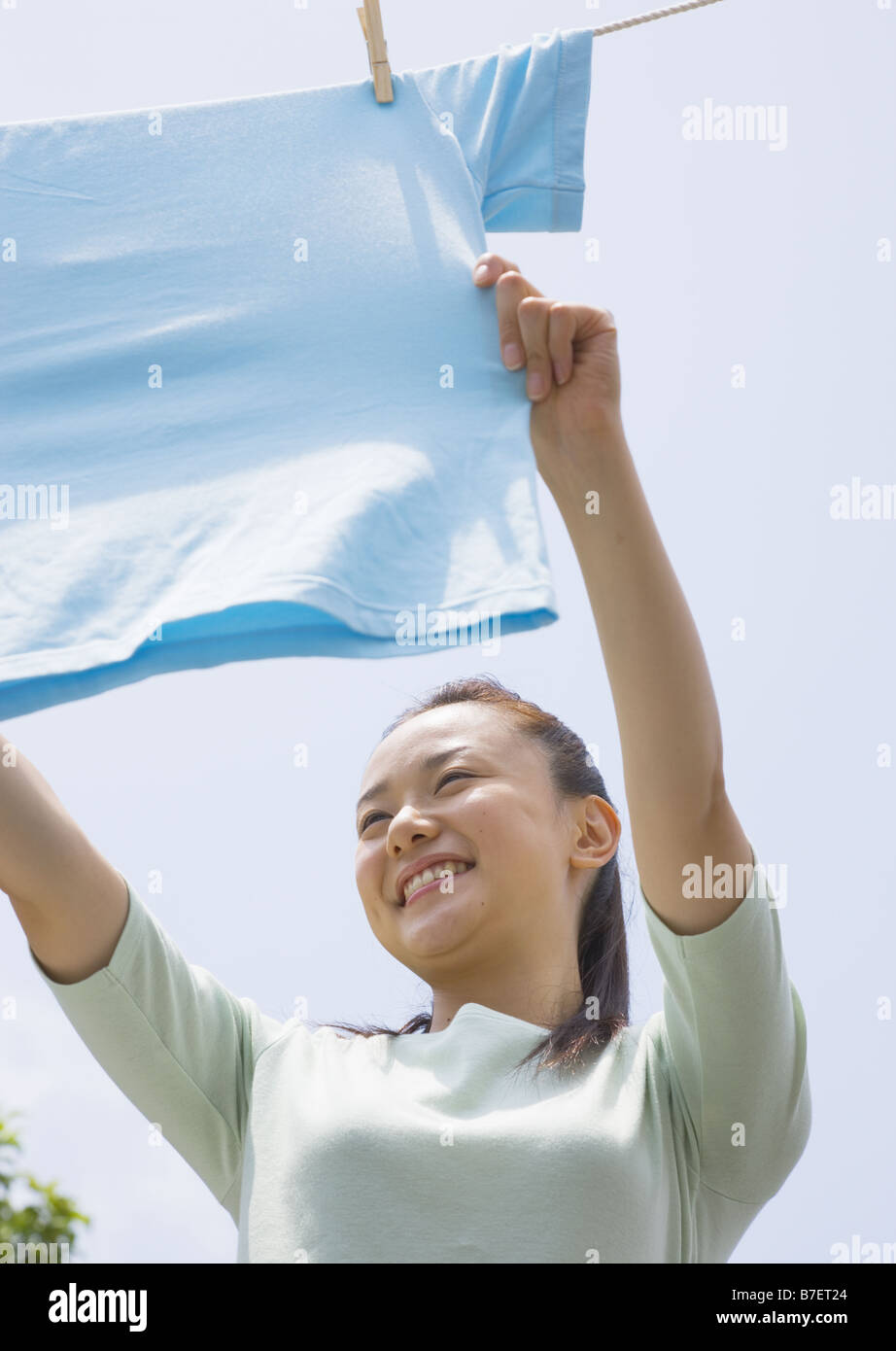 A woman hanging out laundry Stock Photo - Alamy