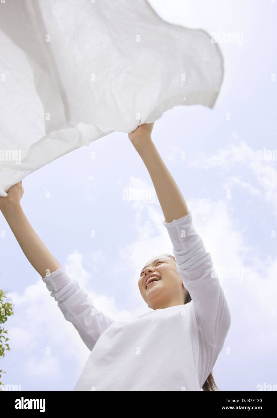 A woman spreading out laundry Stock Photo - Alamy