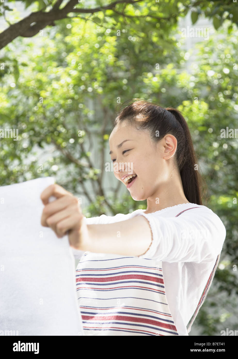 A woman spreading out laundry Stock Photo - Alamy