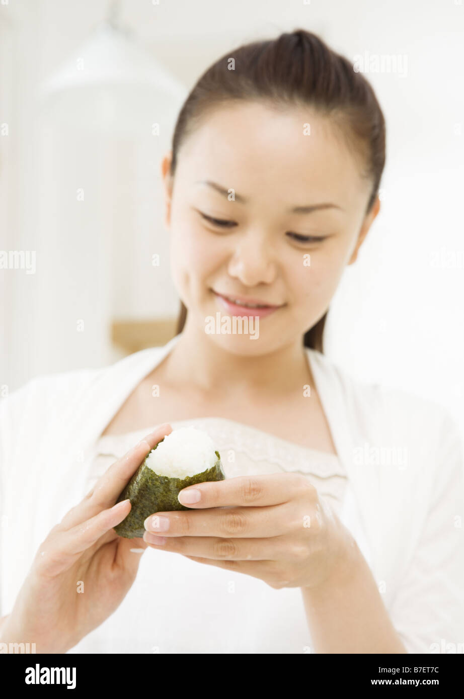 A woman making rice balls Stock Photo - Alamy