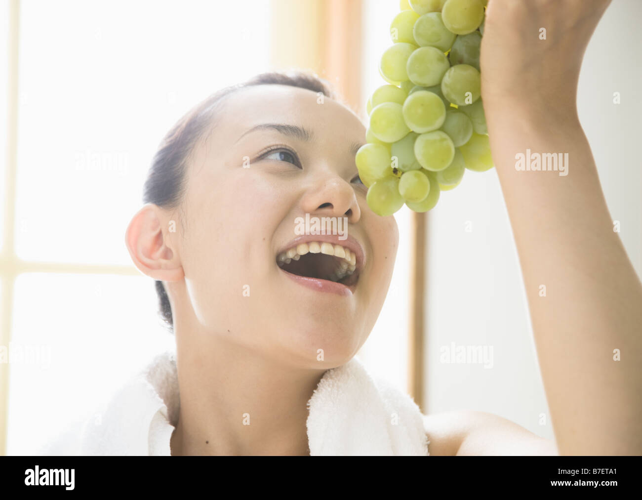 A woman eating grapes Stock Photo - Alamy