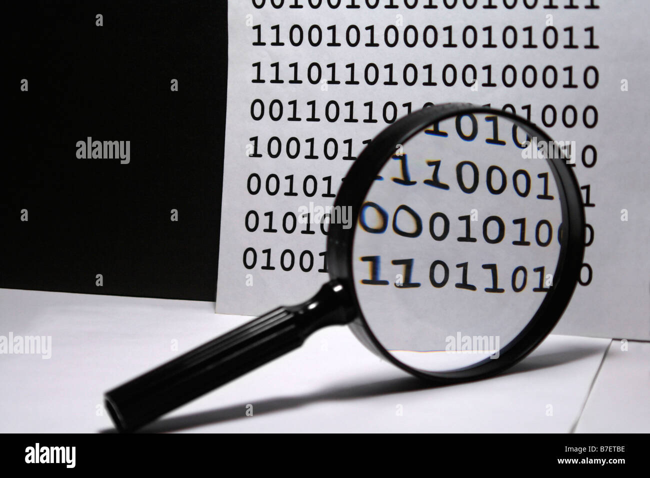 Magnifying glass on binary background Stock Photo - Alamy