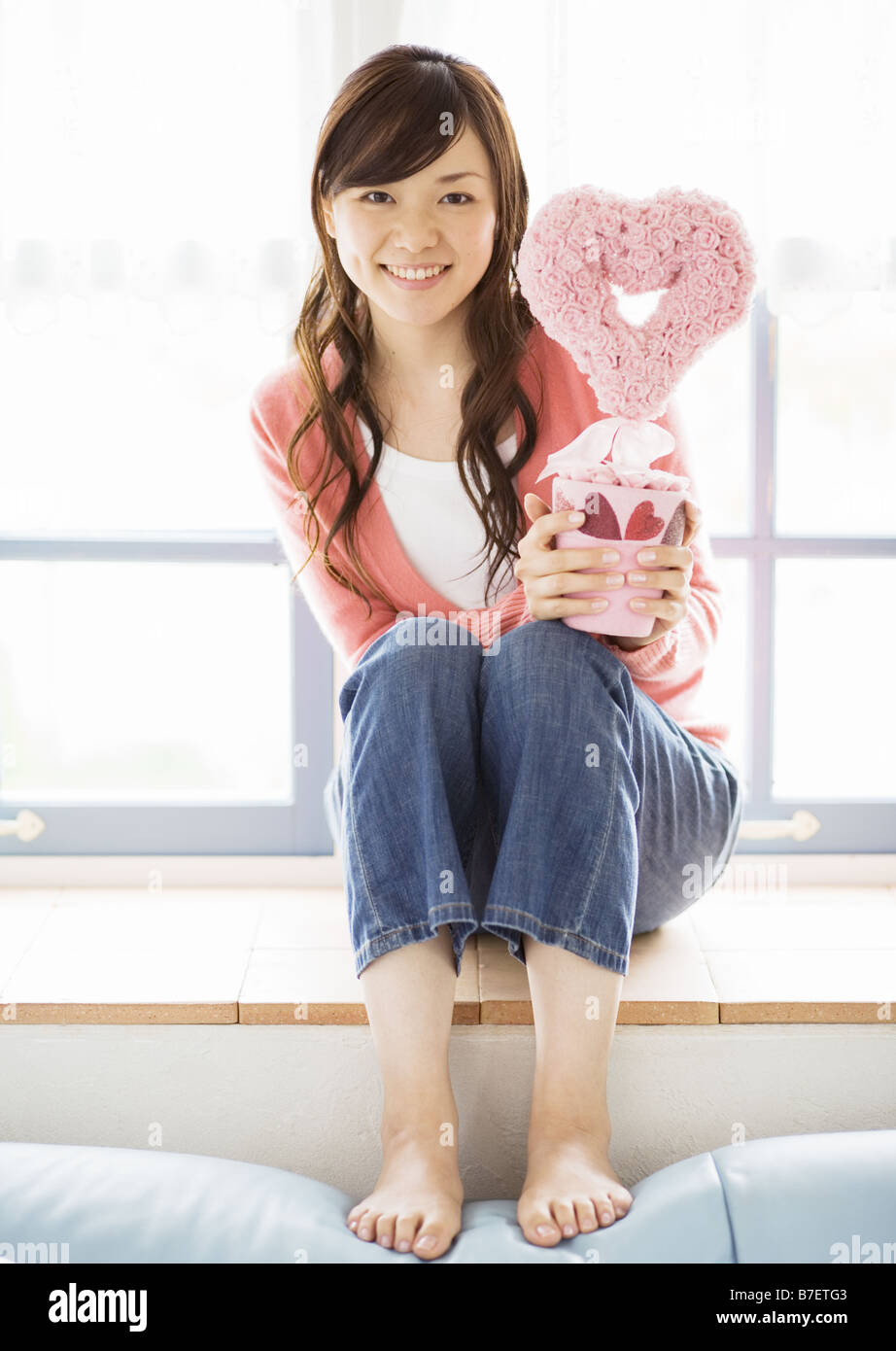 A woman holding a present Stock Photo - Alamy