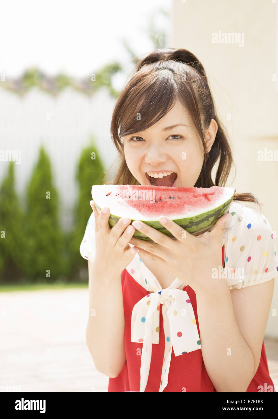 A woman eating watermelon Stock Photo - Alamy