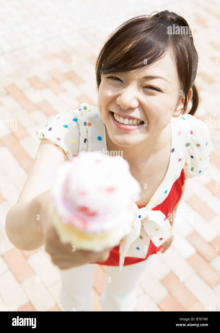 A woman giving ice cream Stock Photo - Alamy