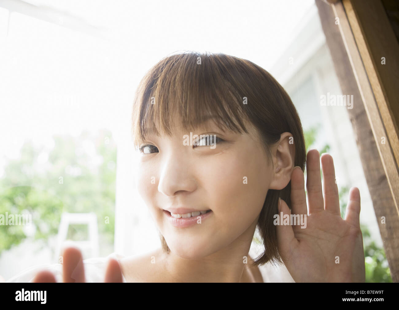 A woman pressing cheek up against the glass window Stock Photo - Alamy