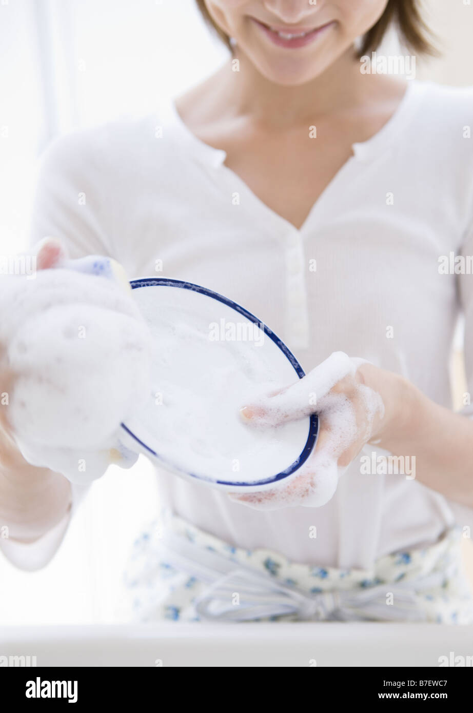 A woman washing a dish Stock Photo - Alamy