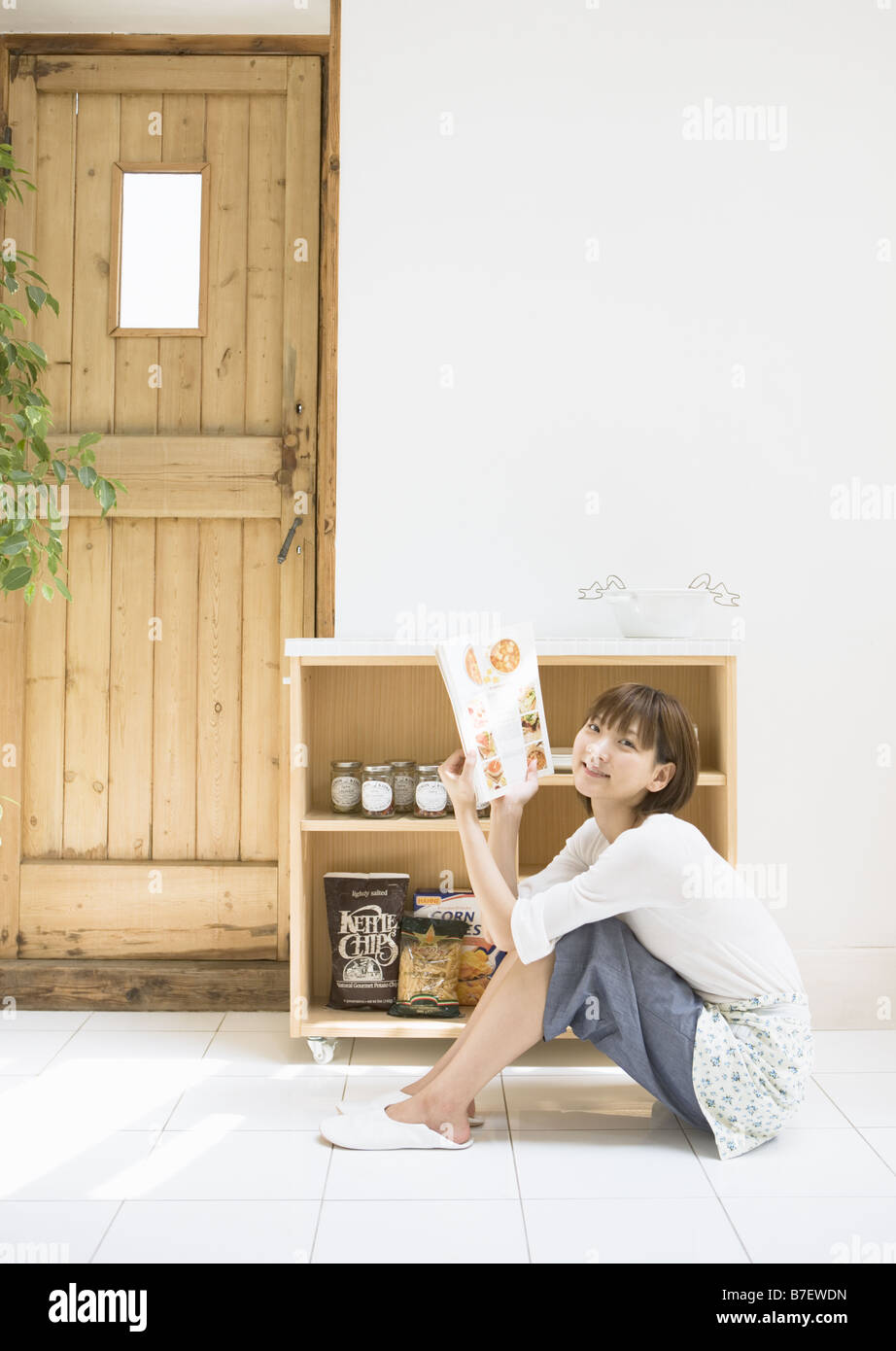 A woman reading cooking book Stock Photo - Alamy
