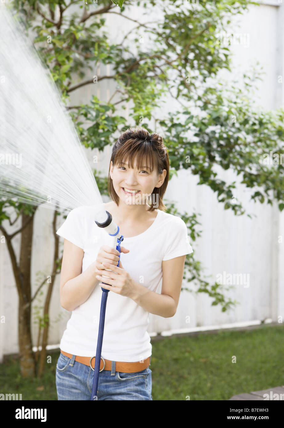 A woman watering Stock Photo - Alamy