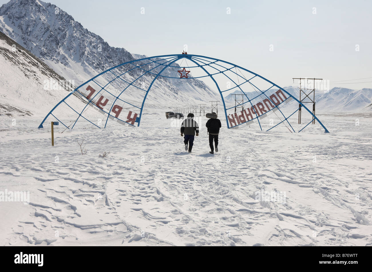Cinematographers walking by arch monument in Arctic Circle, Iultin ...