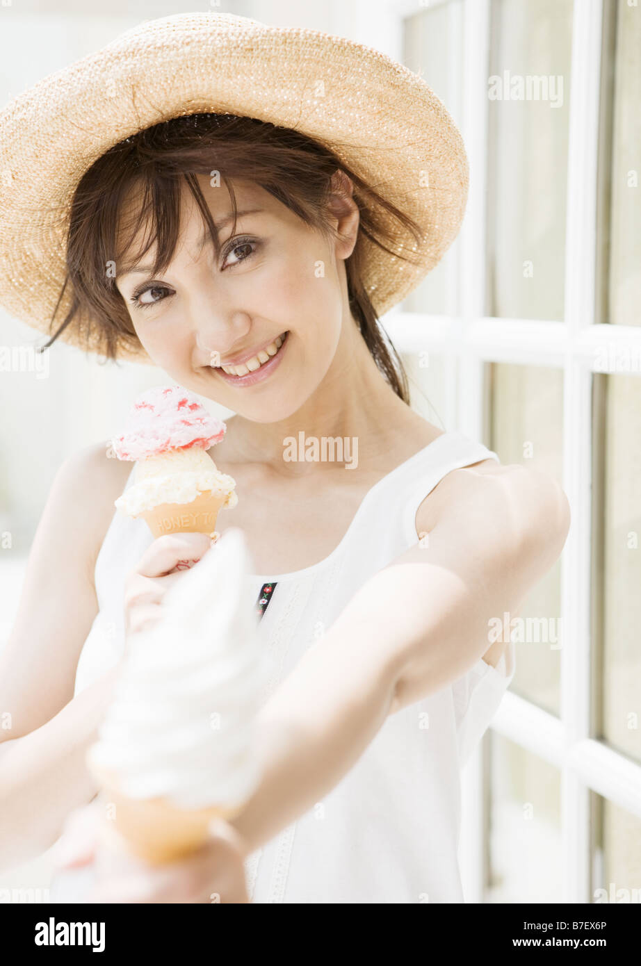 A woman giving ice cream Stock Photo - Alamy